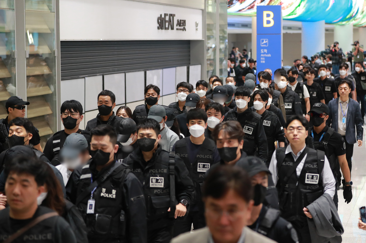 Back in handcuffs: Scam suspects deported from Cambodia arrive in South ...